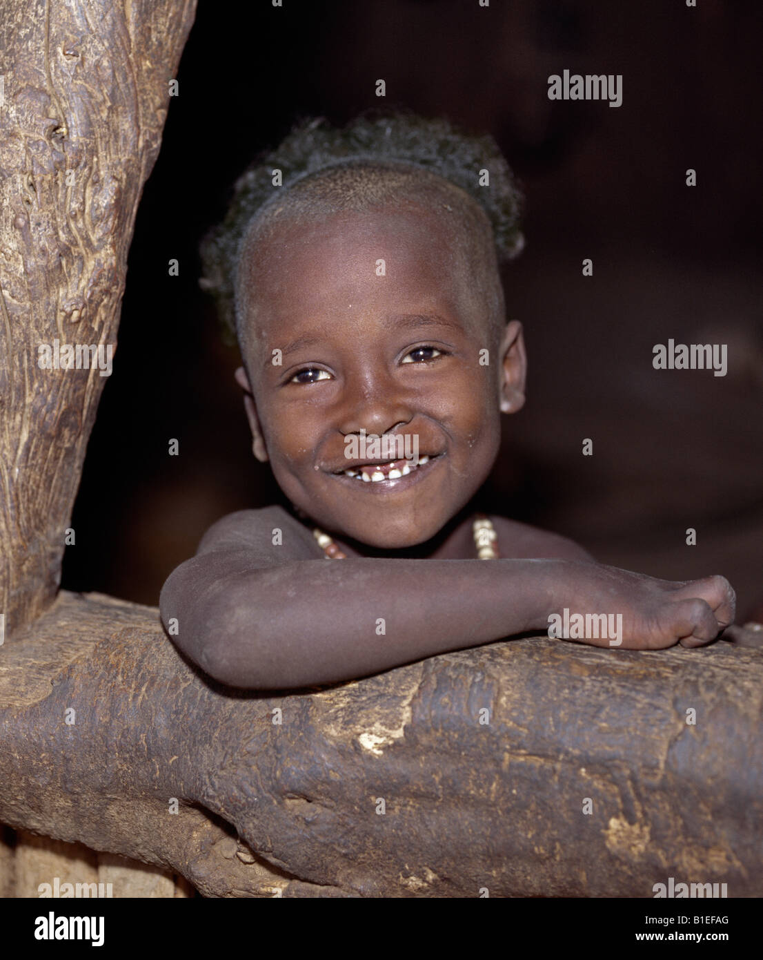 A Hamar child at the entrance to her family's home. The small doorway ...