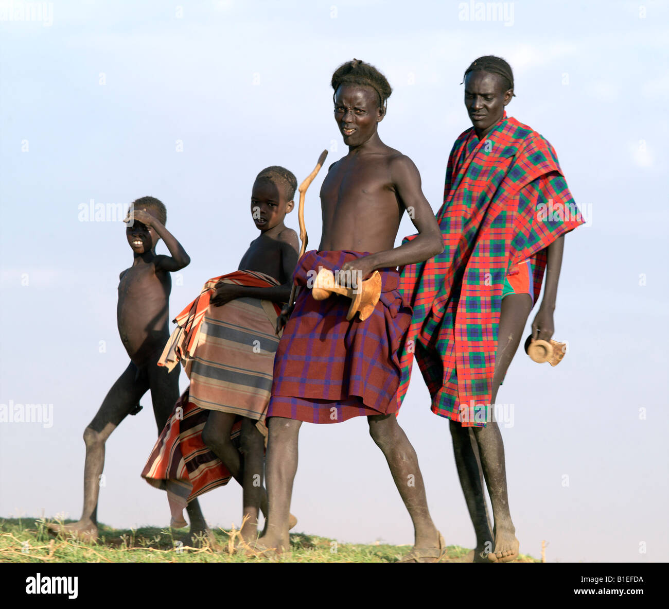 A group of Dassanech walk along a bank of the Omo River in Southwest ...