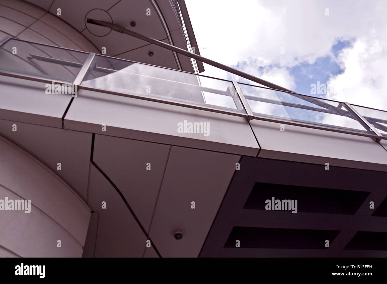 Looking up at overhead walkway on corner of circular building Stock ...