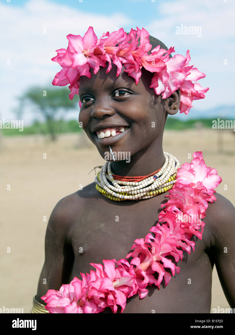 A young Kwegu girl garlanded with wild Desert Rose flowers Stock Photo ...