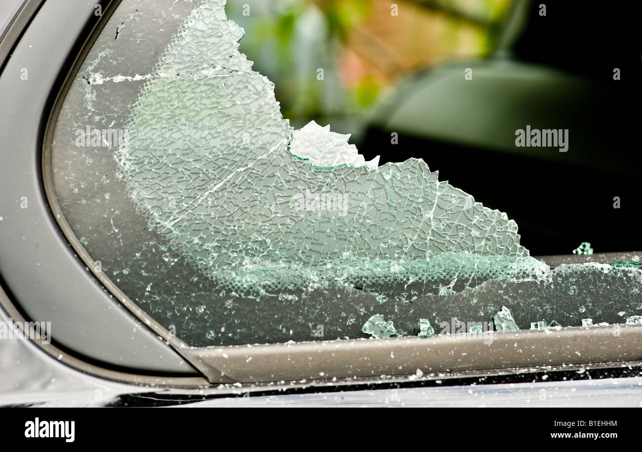 Smashed rear side window on a black car after Stock Photo - Alamy