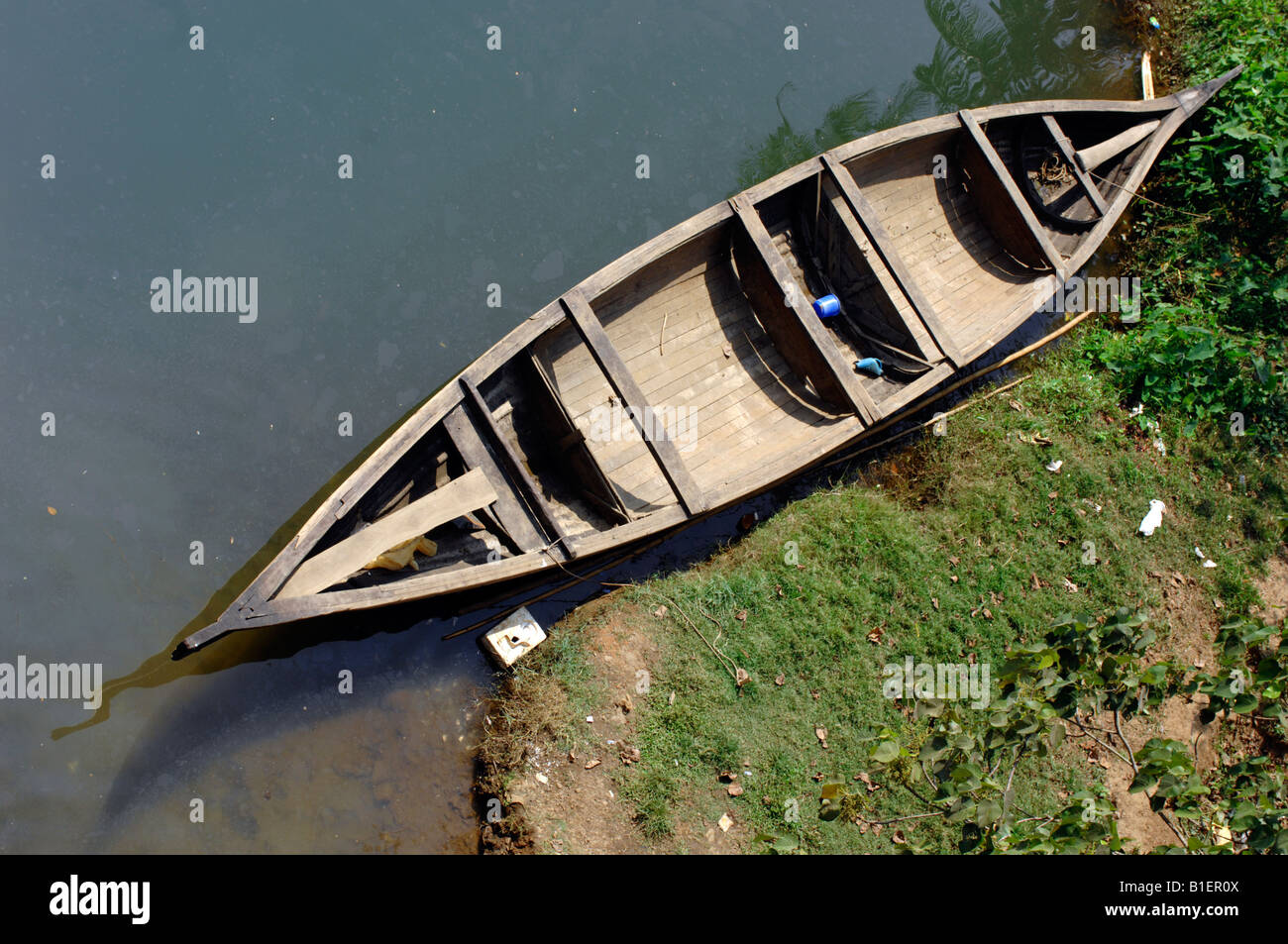 A wooden country-boat to float on water near shore Stock Photo - Alamy