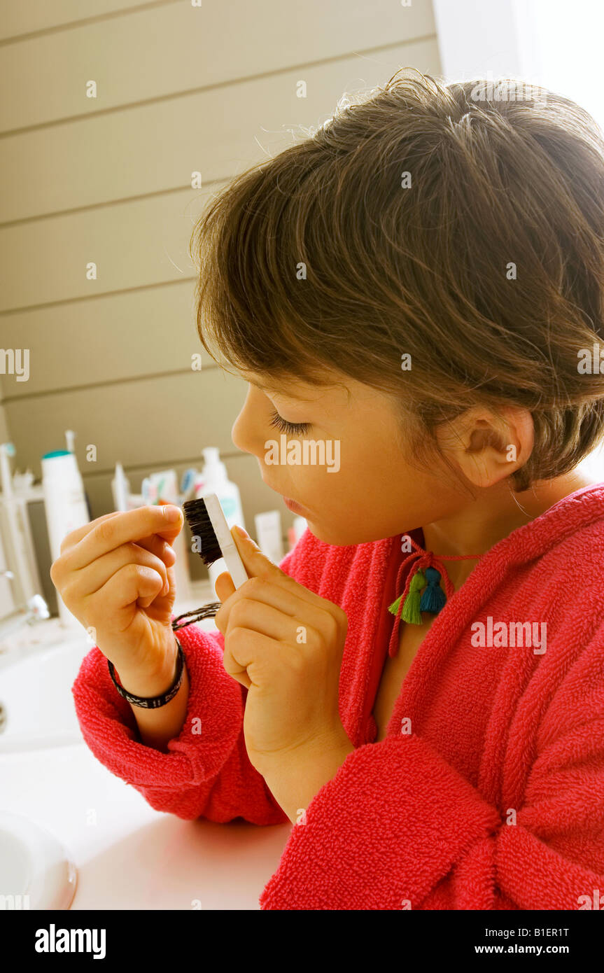 Boy cleaning his nail with a nail brush Stock Photo - Alamy