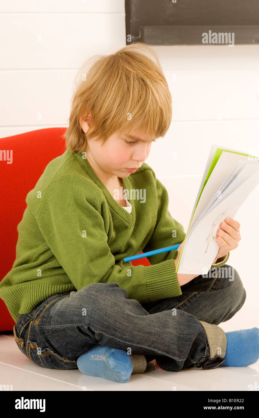 Boy writing pencil on notepad hi-res stock photography and images - Alamy