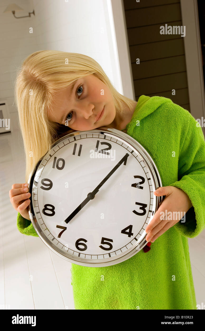 Portrait of a girl holding a clock Stock Photo - Alamy