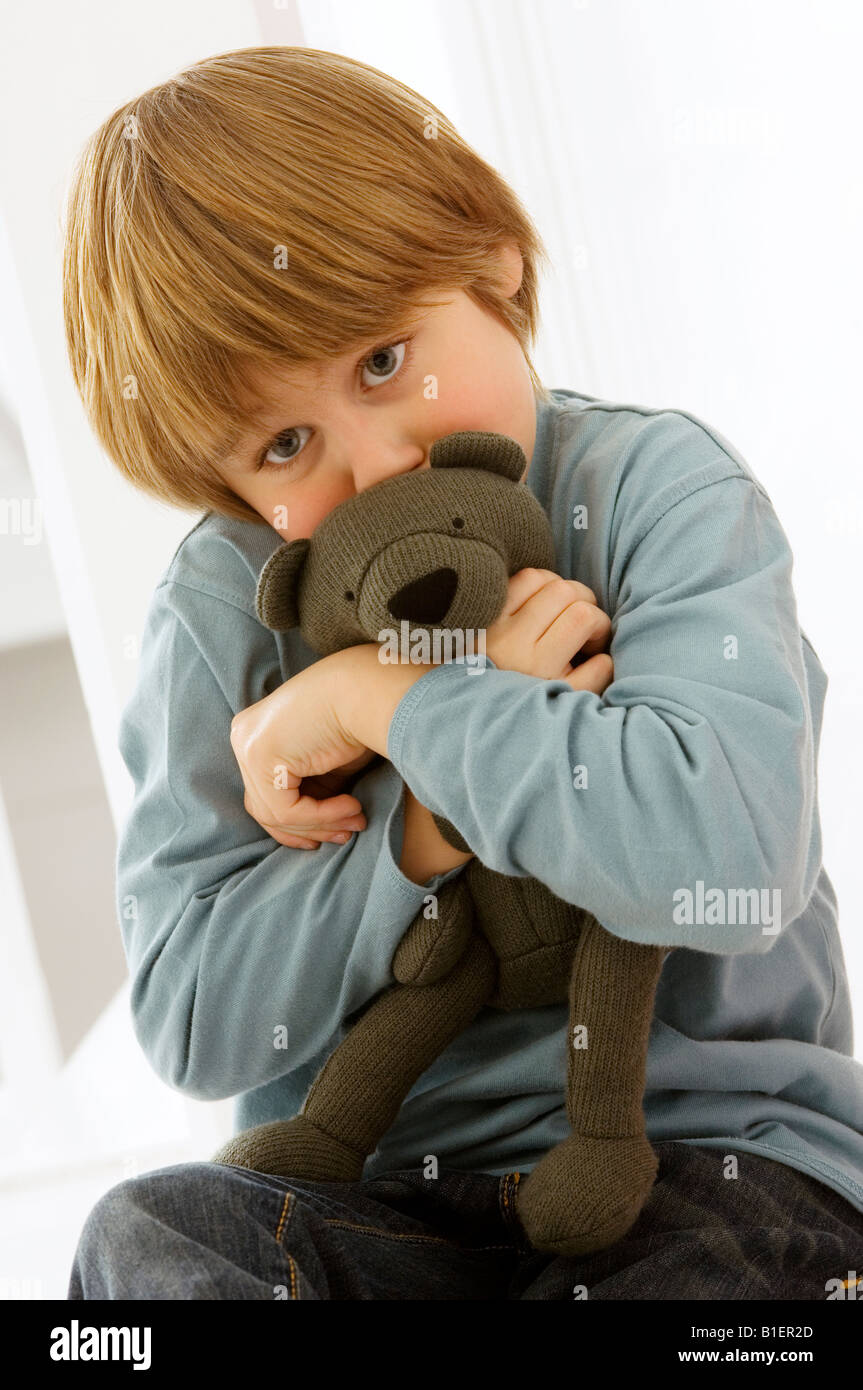Boy holding a teddy bear Stock Photo - Alamy
