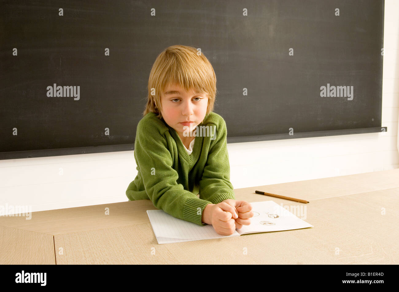 Boy leaning on a table Stock Photo - Alamy