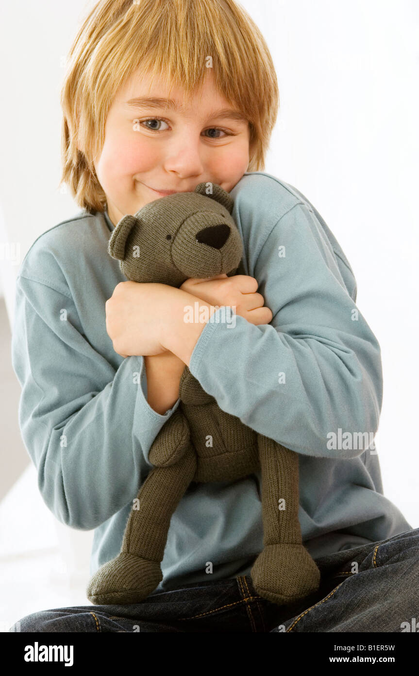 Portrait of a boy holding a teddy bear Stock Photo - Alamy