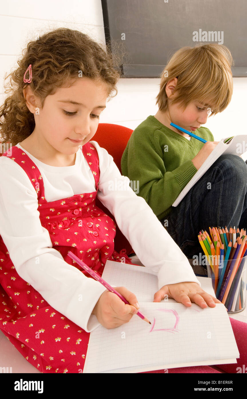 Two children drawing on a notepad Stock Photo - Alamy
