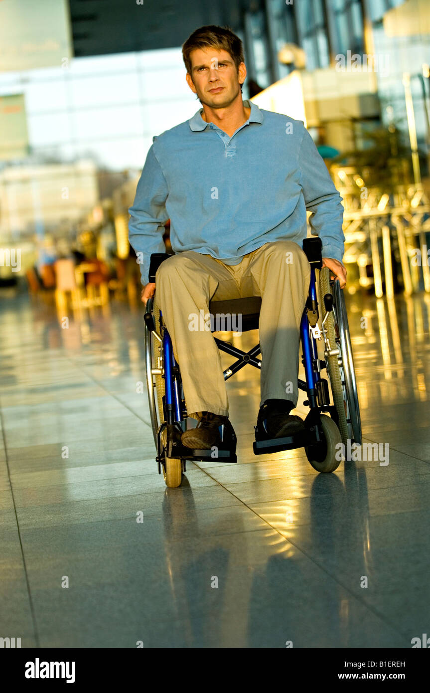 Mid adult man sitting in a wheelchair Stock Photo - Alamy