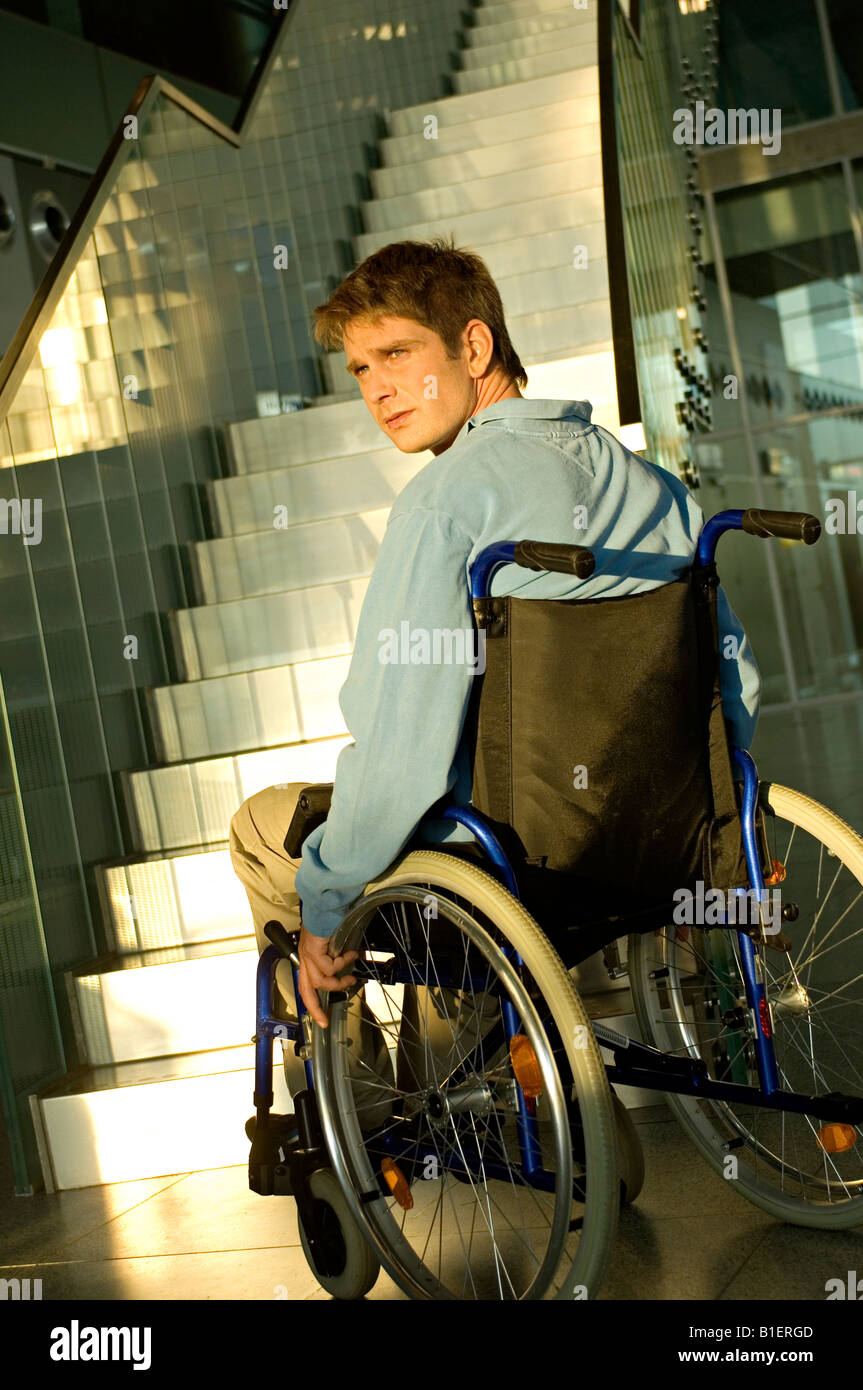 Mid adult man sitting in a wheelchair Stock Photo - Alamy
