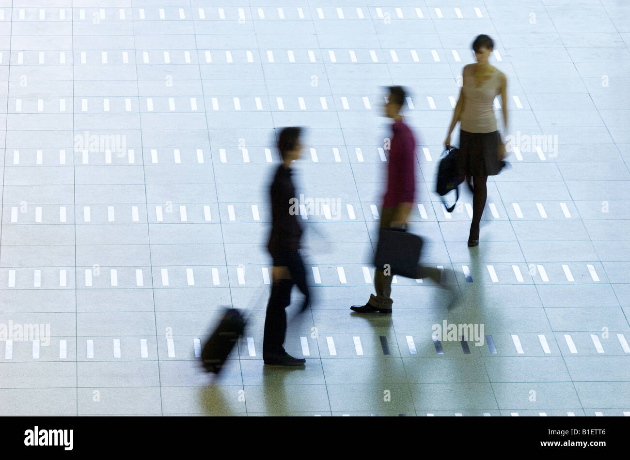 High angle view of three passengers walking at an airport lobby Stock ...