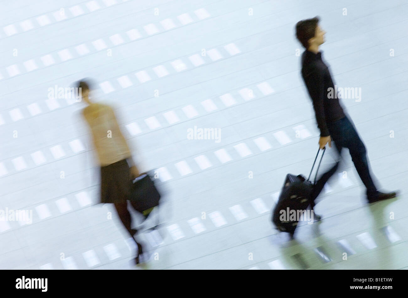 High angle view of two passengers walking at an airport Stock Photo - Alamy