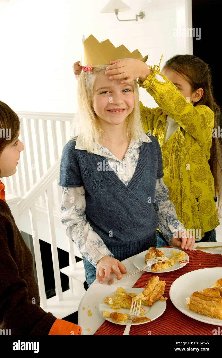 Girl putting a crown on her friend's head Stock Photo - Alamy