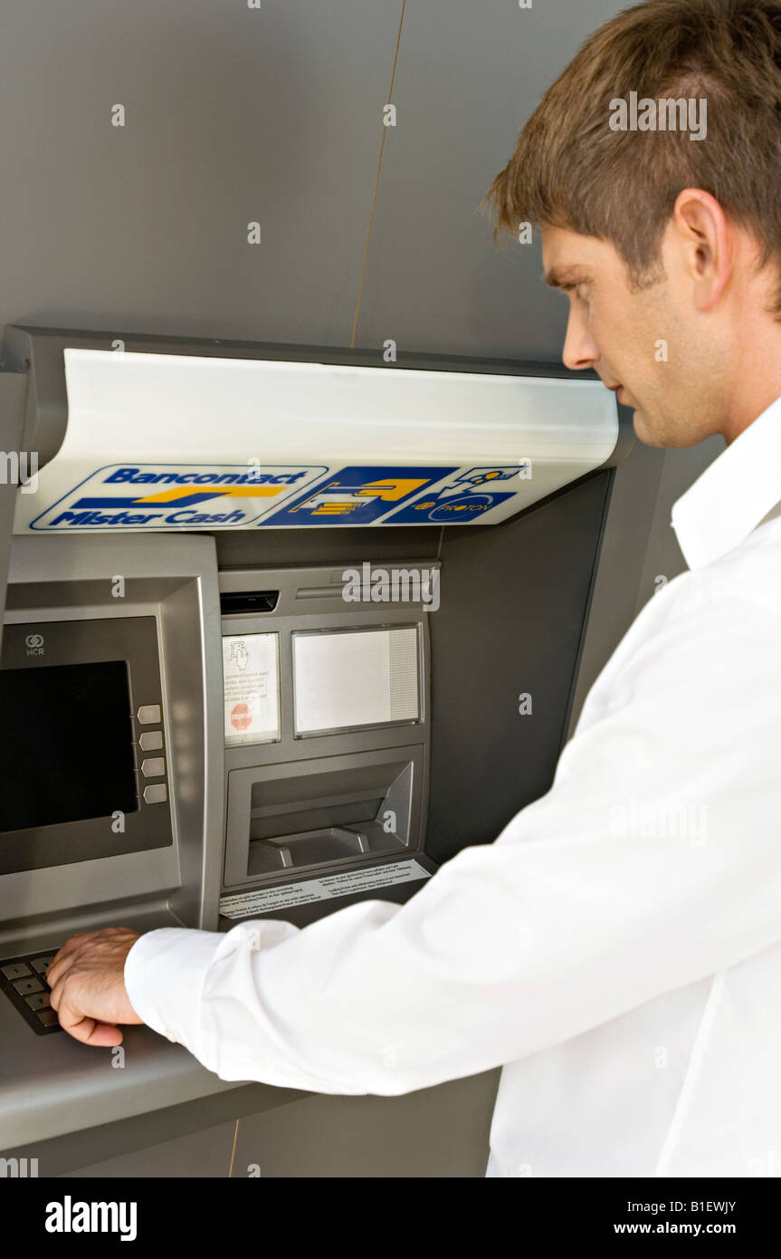 Side profile of a businessman using an ATM Stock Photo - Alamy