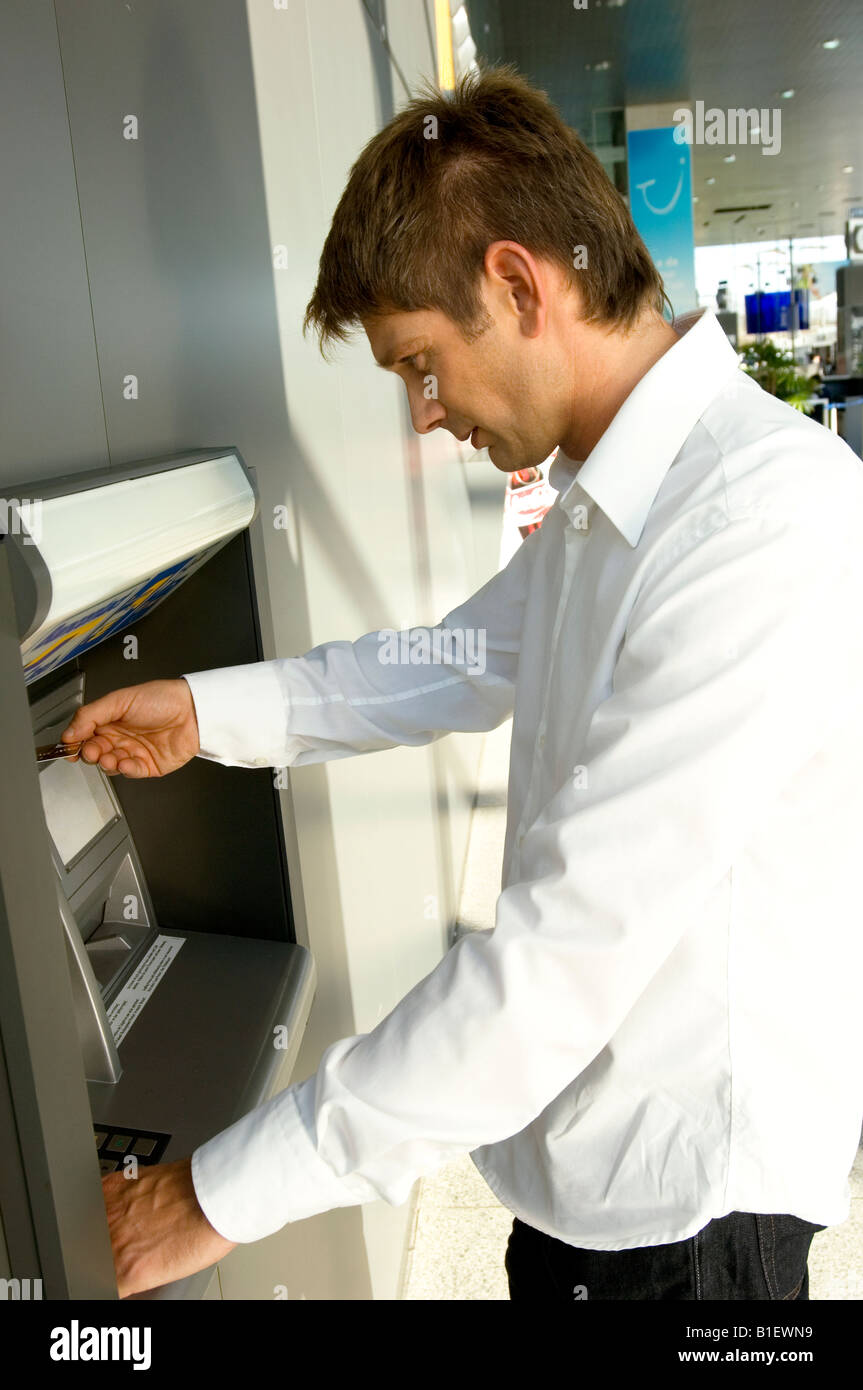 Side profile of a businessman using an ATM Stock Photo - Alamy