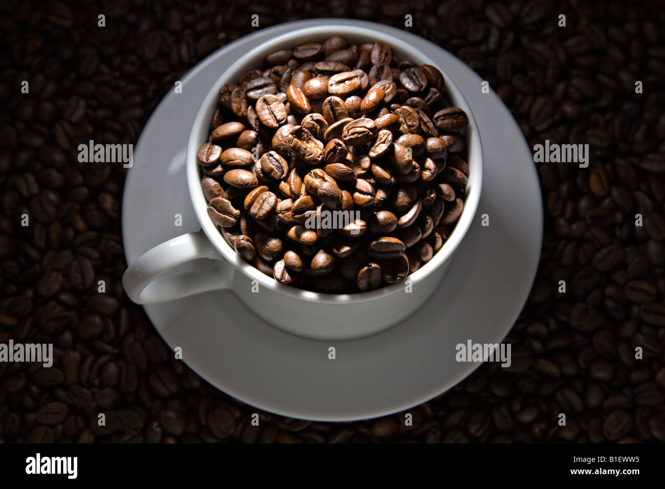 Coffee cup filled with coffee beans Stock Photo - Alamy