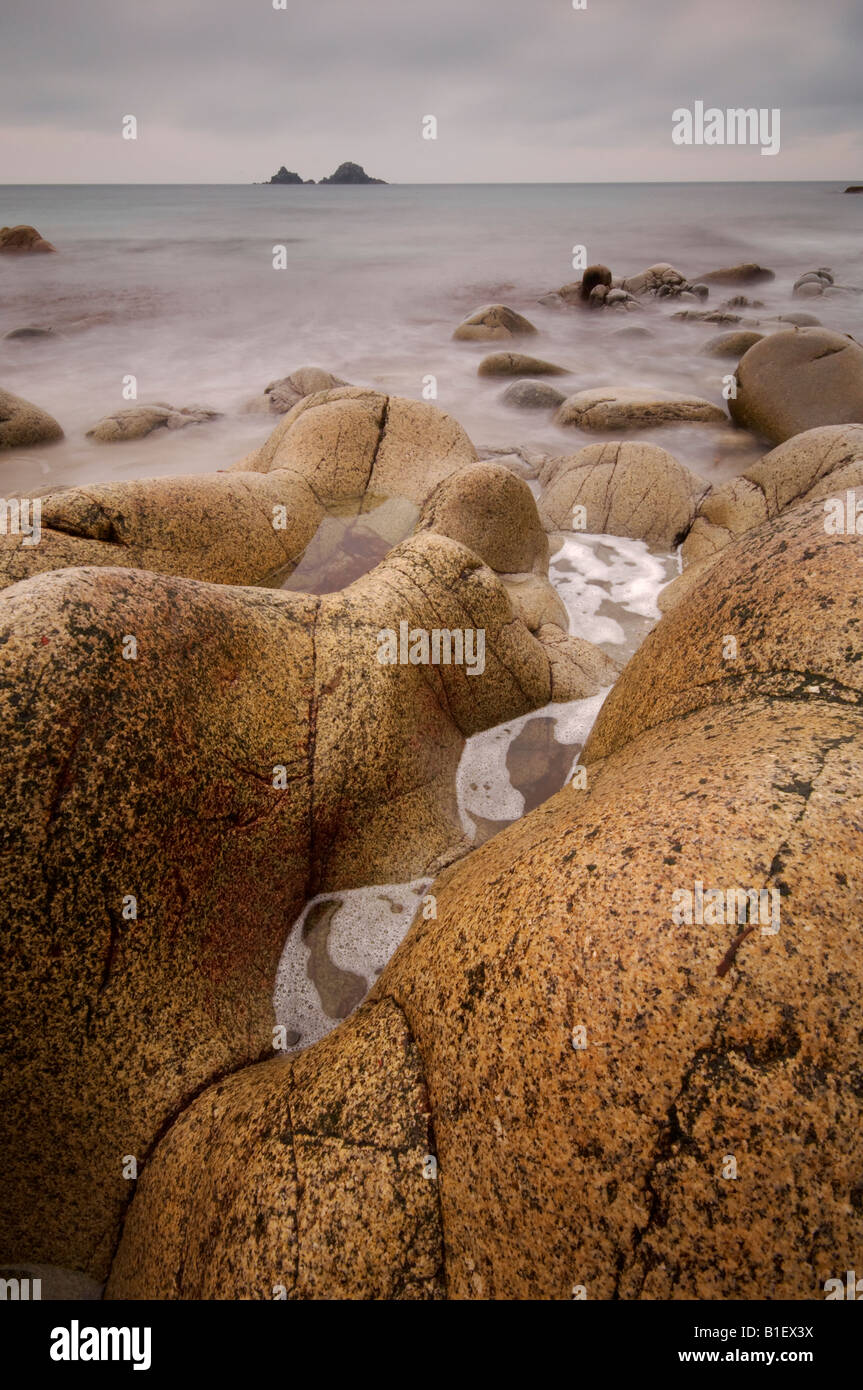 Dusk light over the unusual rock formations on Porth nanven beach near ...