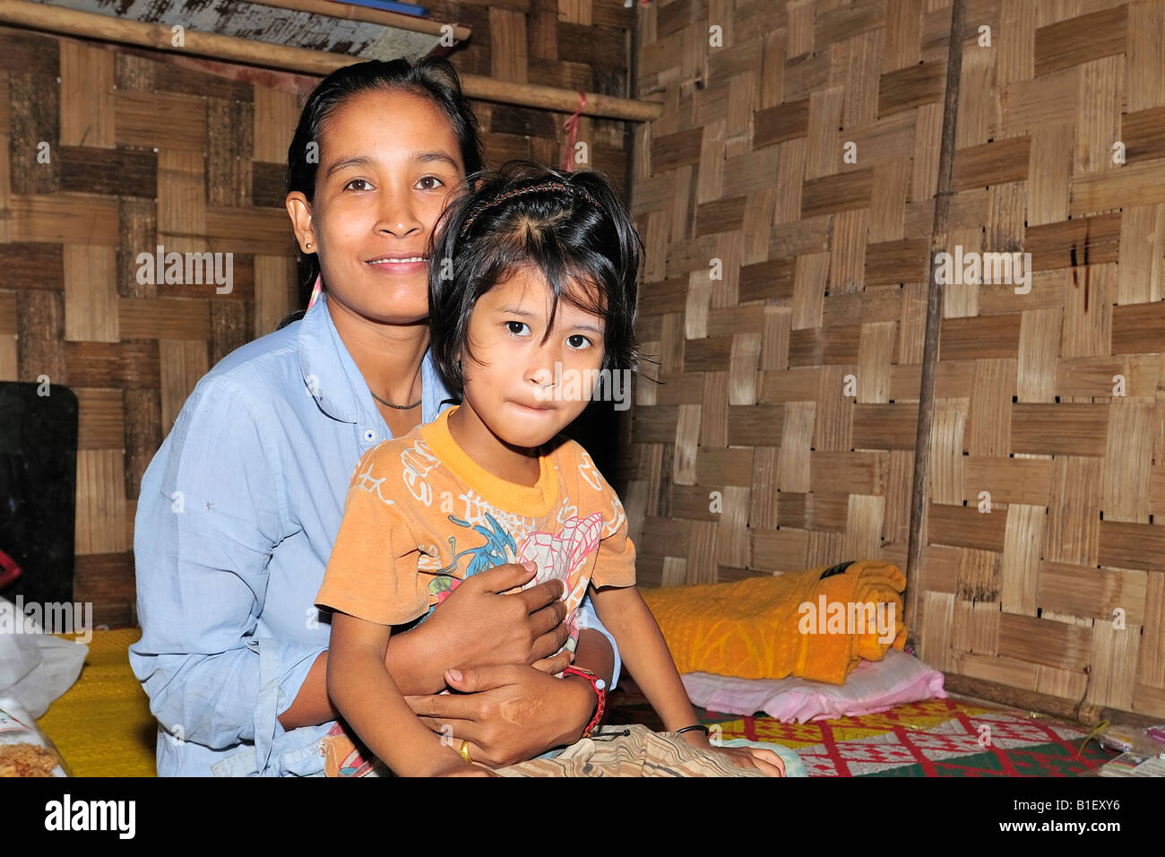 Mon tribal family in their primitive house Stock Photo - Alamy