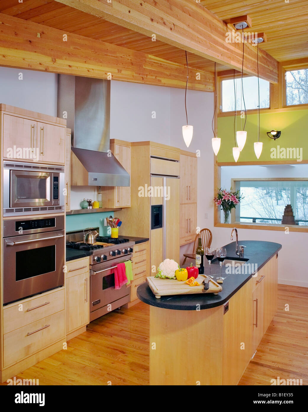 Kitchen view of a contempory residence with maple woodwork and exposed ...