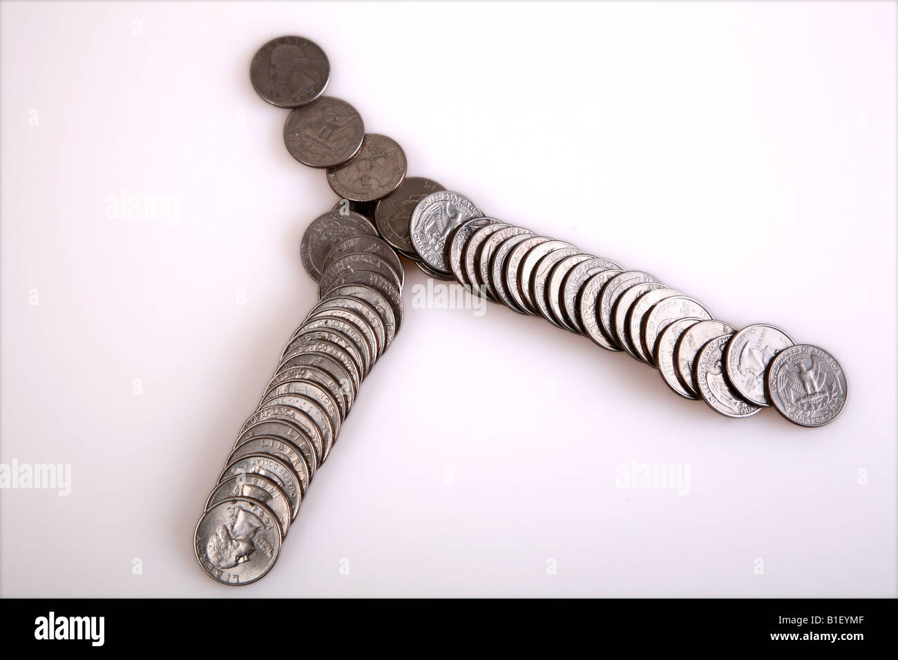 Old money coins sprawled in an upside down Y shape on a white ...