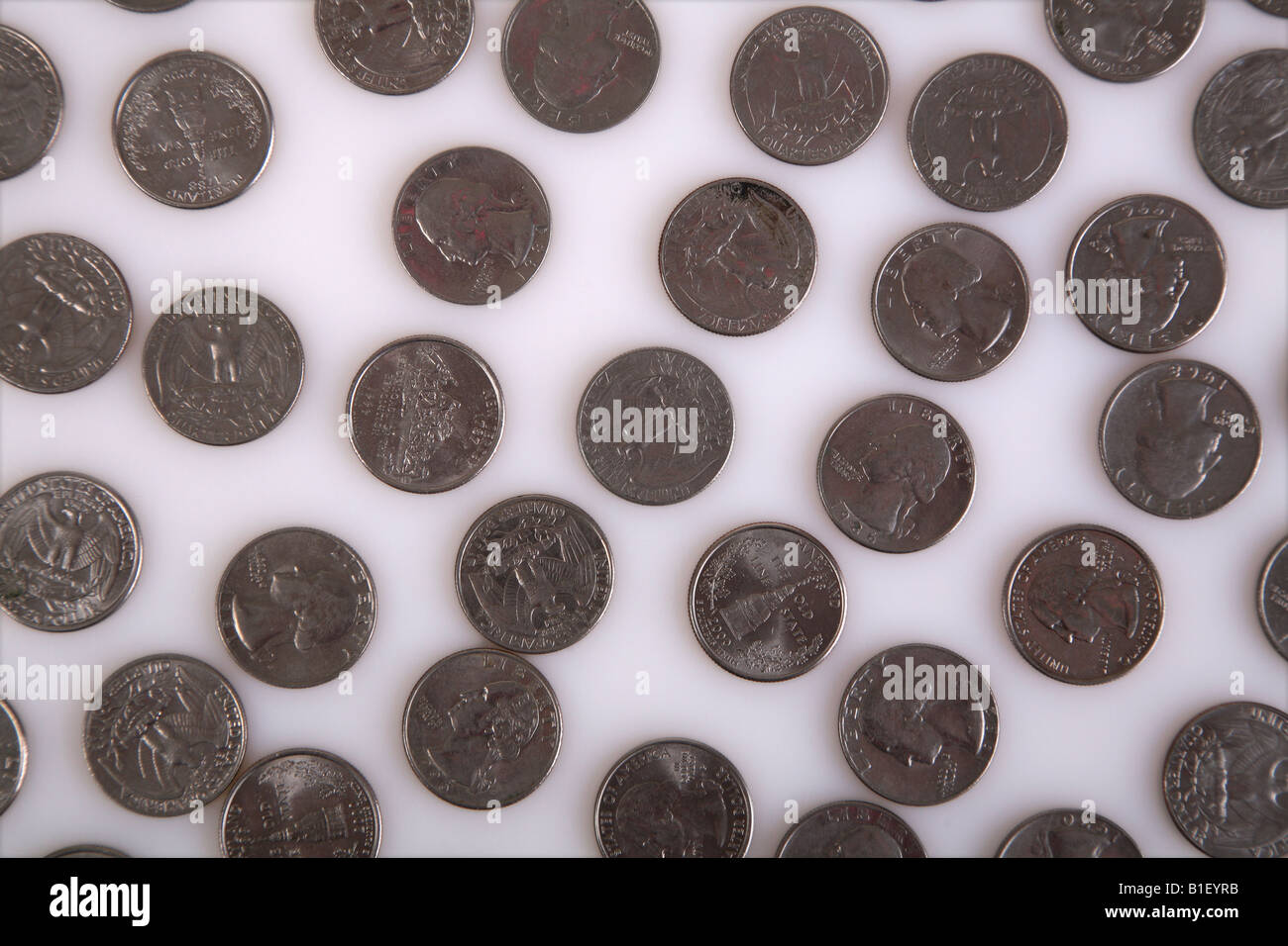 American quarter dollar coins on a white background Stock Photo - Alamy