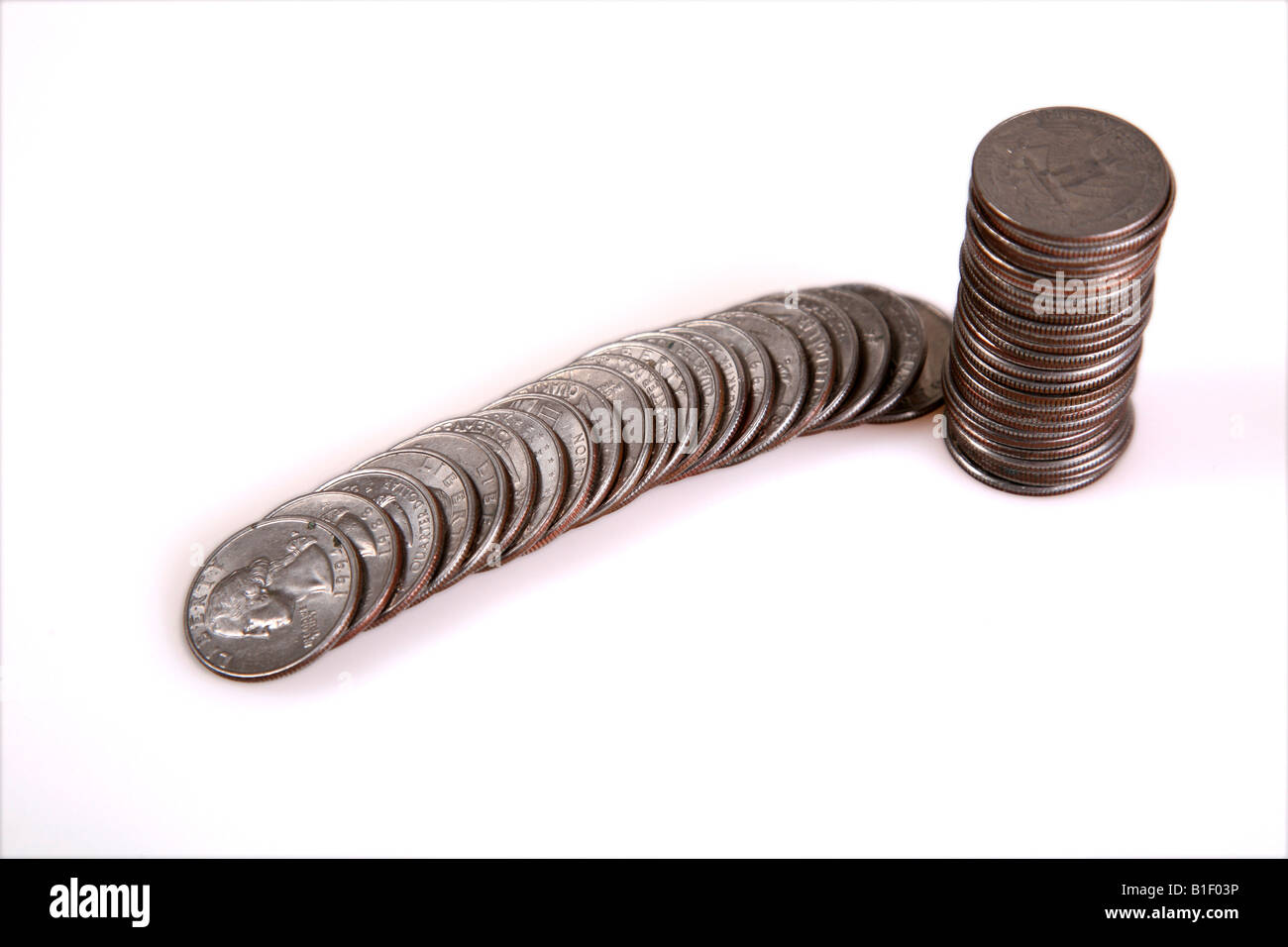 Money coins arranged in a vertical and horizontal way on a white ...