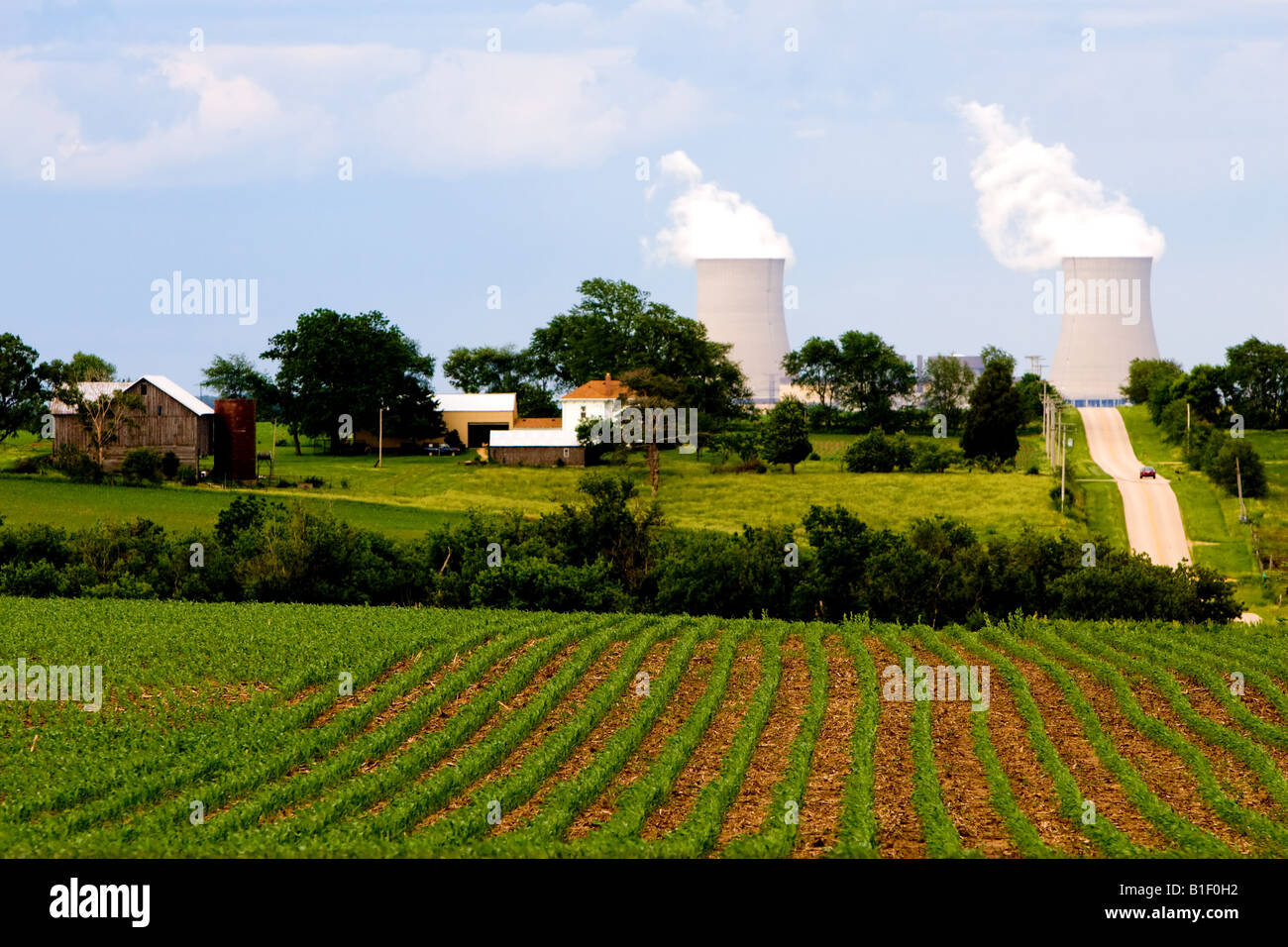 The Byron Nuclear Power Plant stands over late spring corn crops near ...