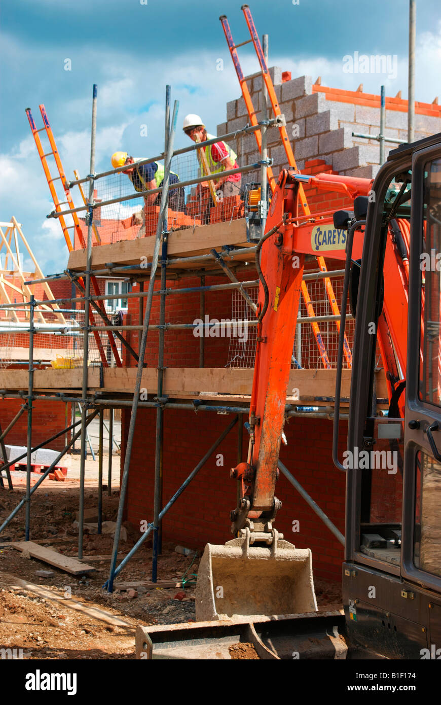 Two builders working on large building site Stock Photo - Alamy