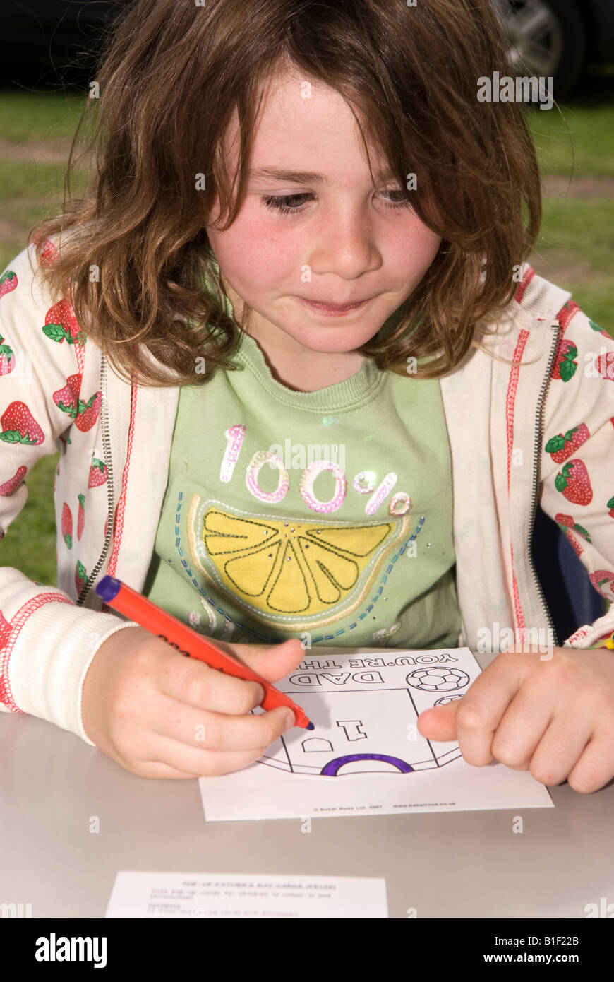 Young pupil using colouring pen at a school summer fair Isleworth ...