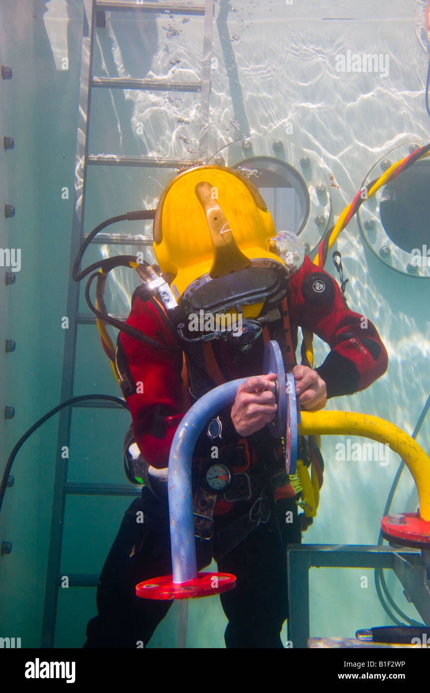 Deep sea diver demonstrating the joining of two pipe flanges Stock ...