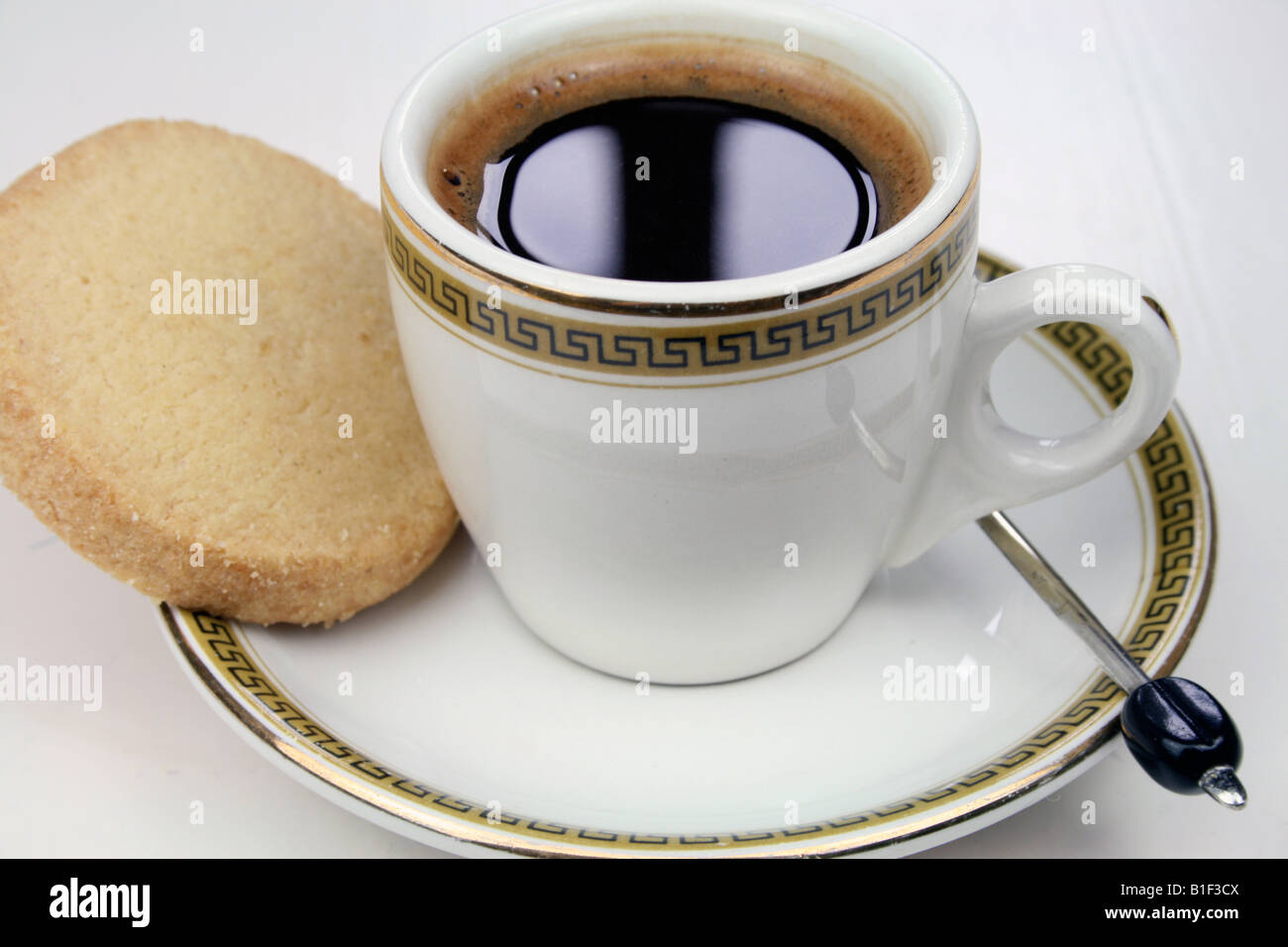 espresso, black coffee in a small coffee cup with shortbread biscuit ...