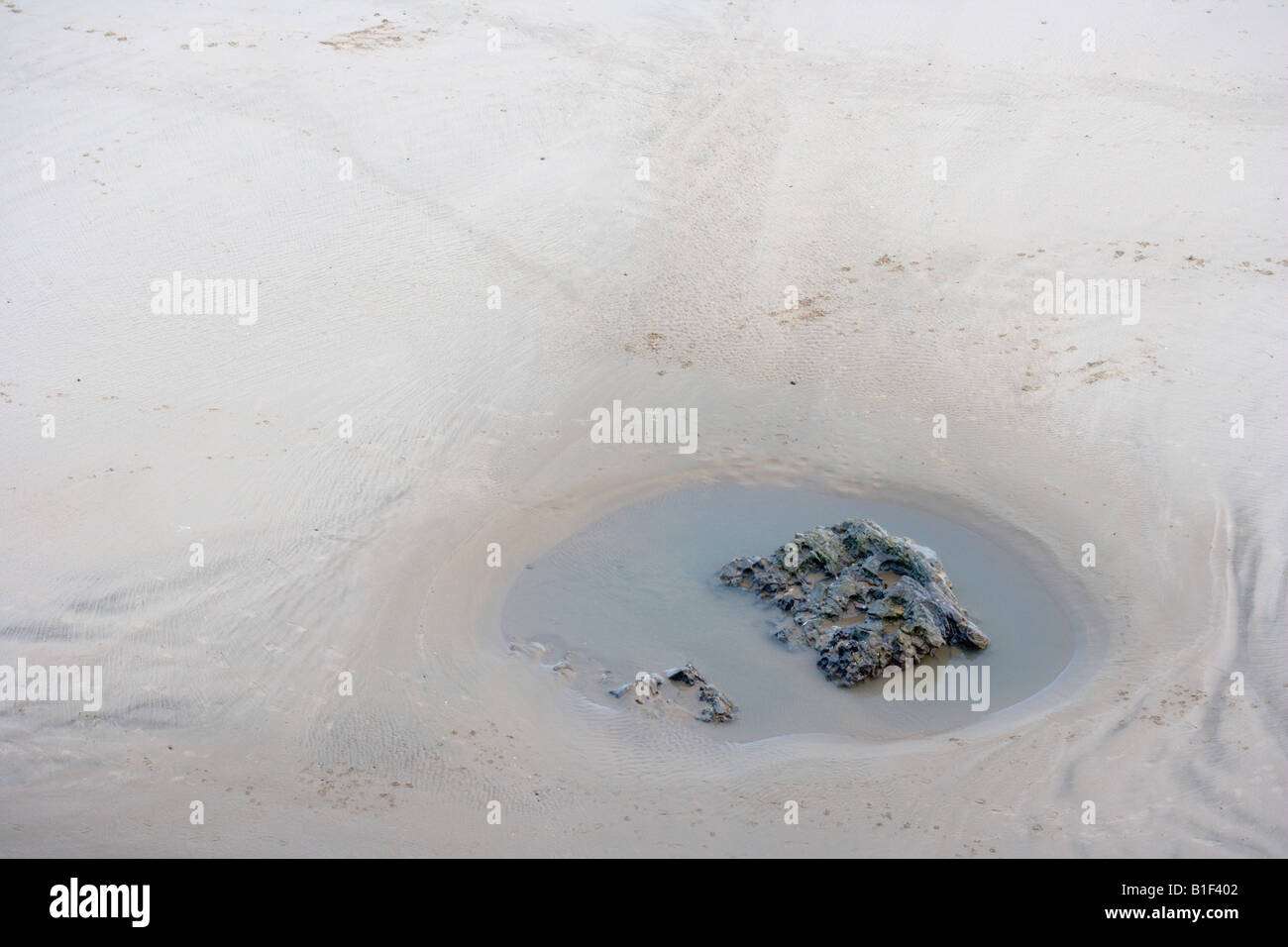 Puddle on sandy beach Tenby Wales Stock Photo - Alamy