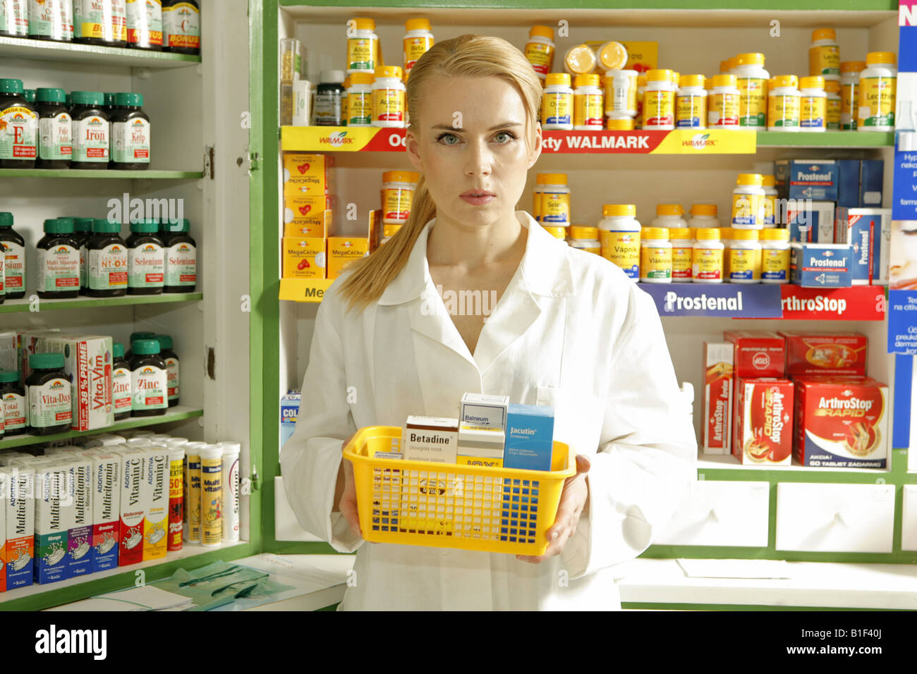 Young female pharmacist holding basket with drugs Stock Photo - Alamy