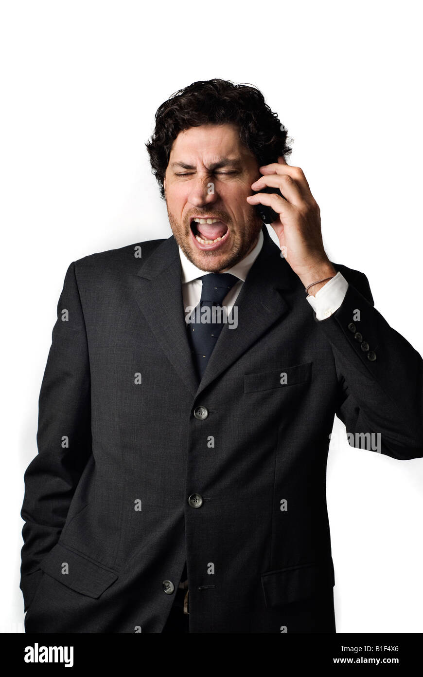 Angry business man yelling at mobile phone white background Stock Photo ...