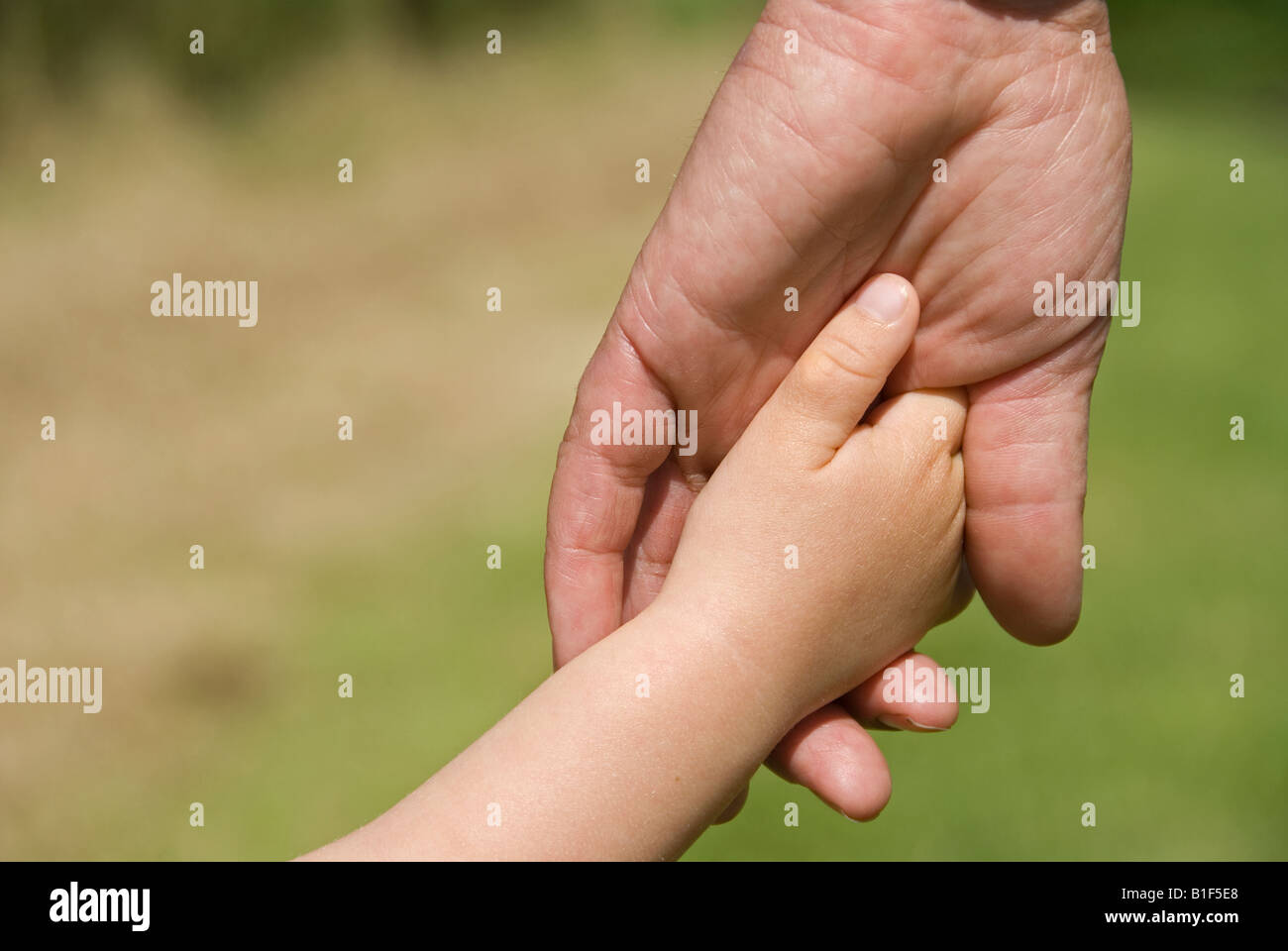 My mother holding a childs hand hi-res stock photography and images - Alamy