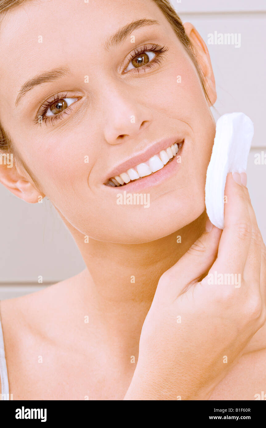 Portrait of a young woman applying face powder Stock Photo - Alamy