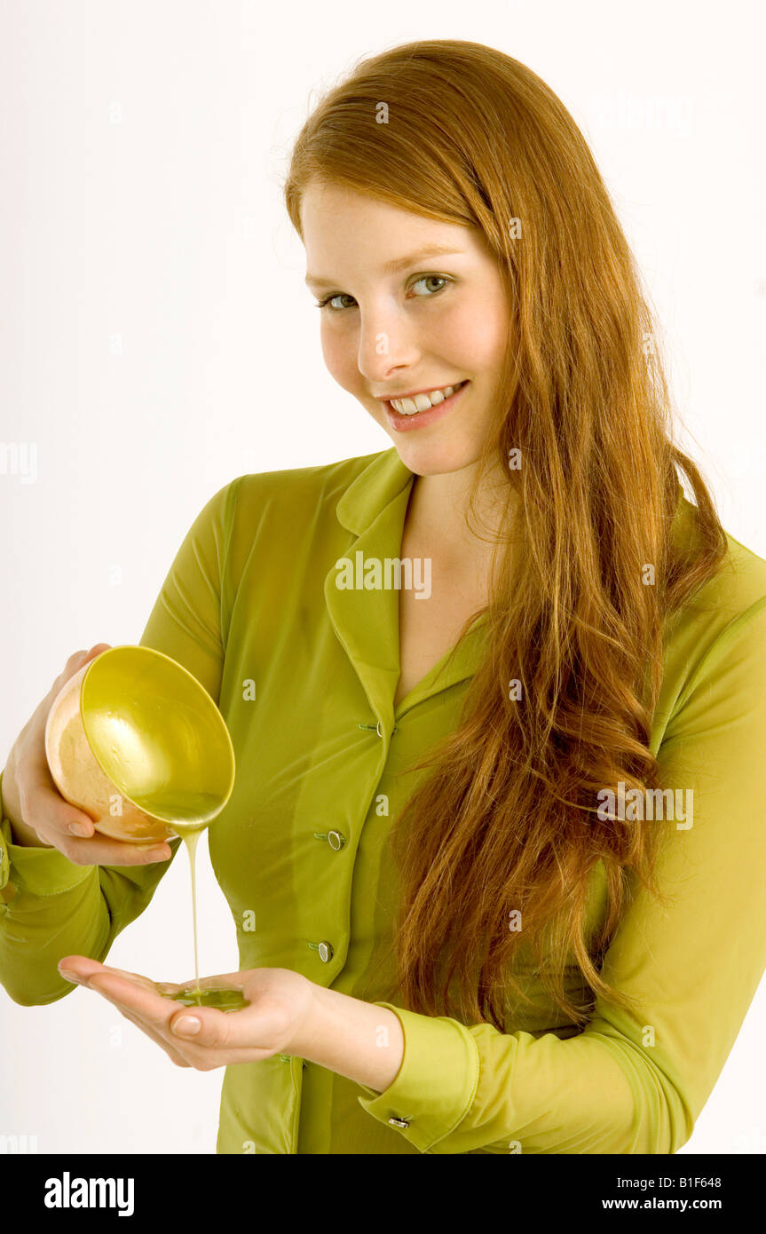 Woman pouring oil hair hi-res stock photography and images - Alamy