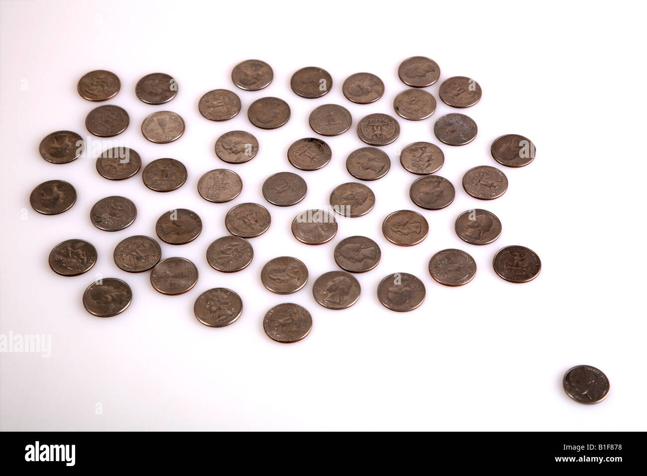 Coins spread out on a white background Stock Photo - Alamy