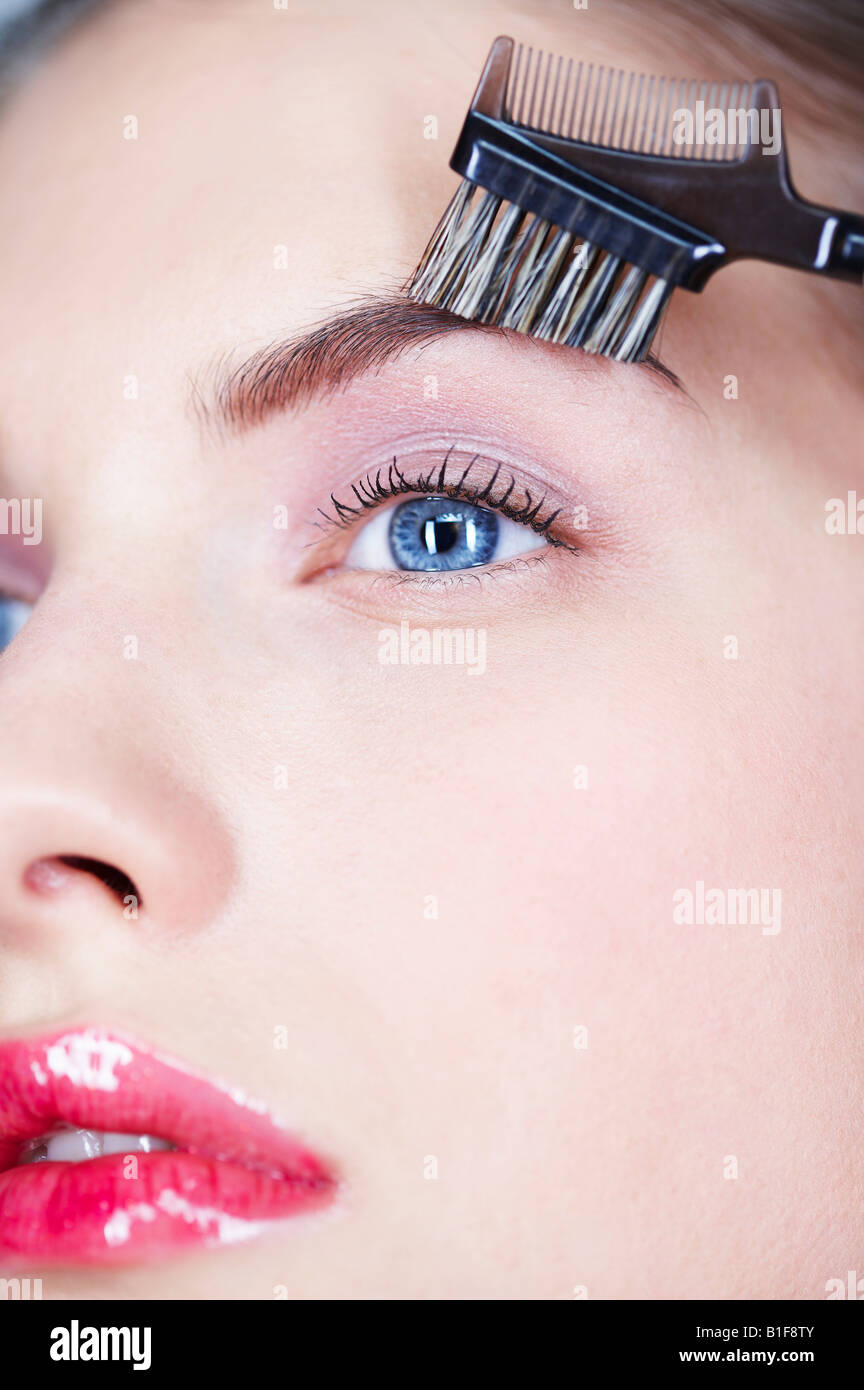Woman brushing eyebrow Stock Photo - Alamy