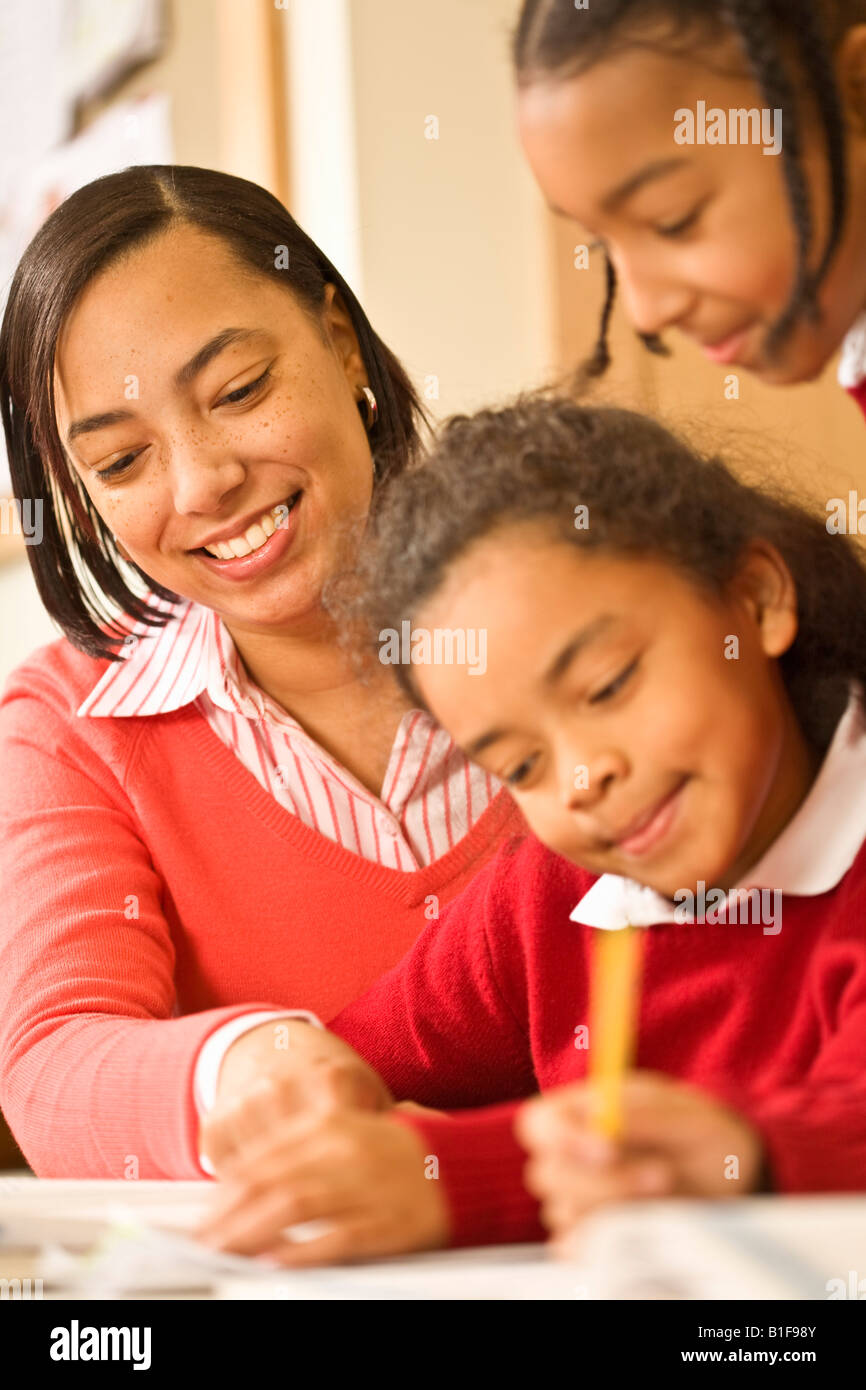 African female teacher helping student Stock Photo - Alamy