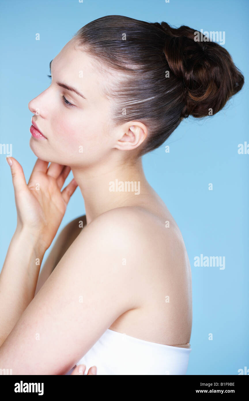 Young woman touching her cheek, side view Stock Photo - Alamy