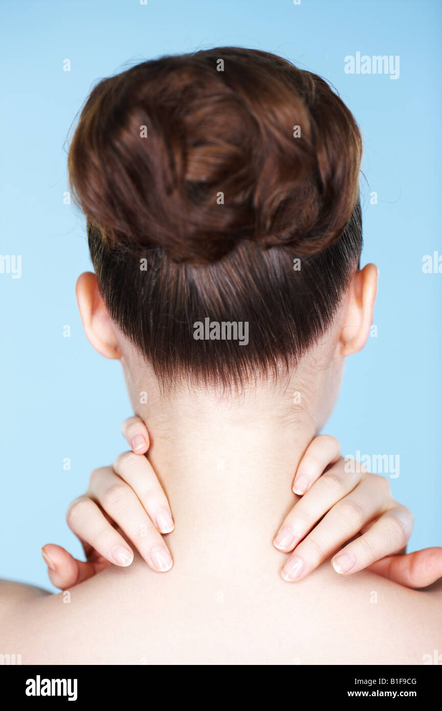 Woman touching her neck, rear view Stock Photo - Alamy