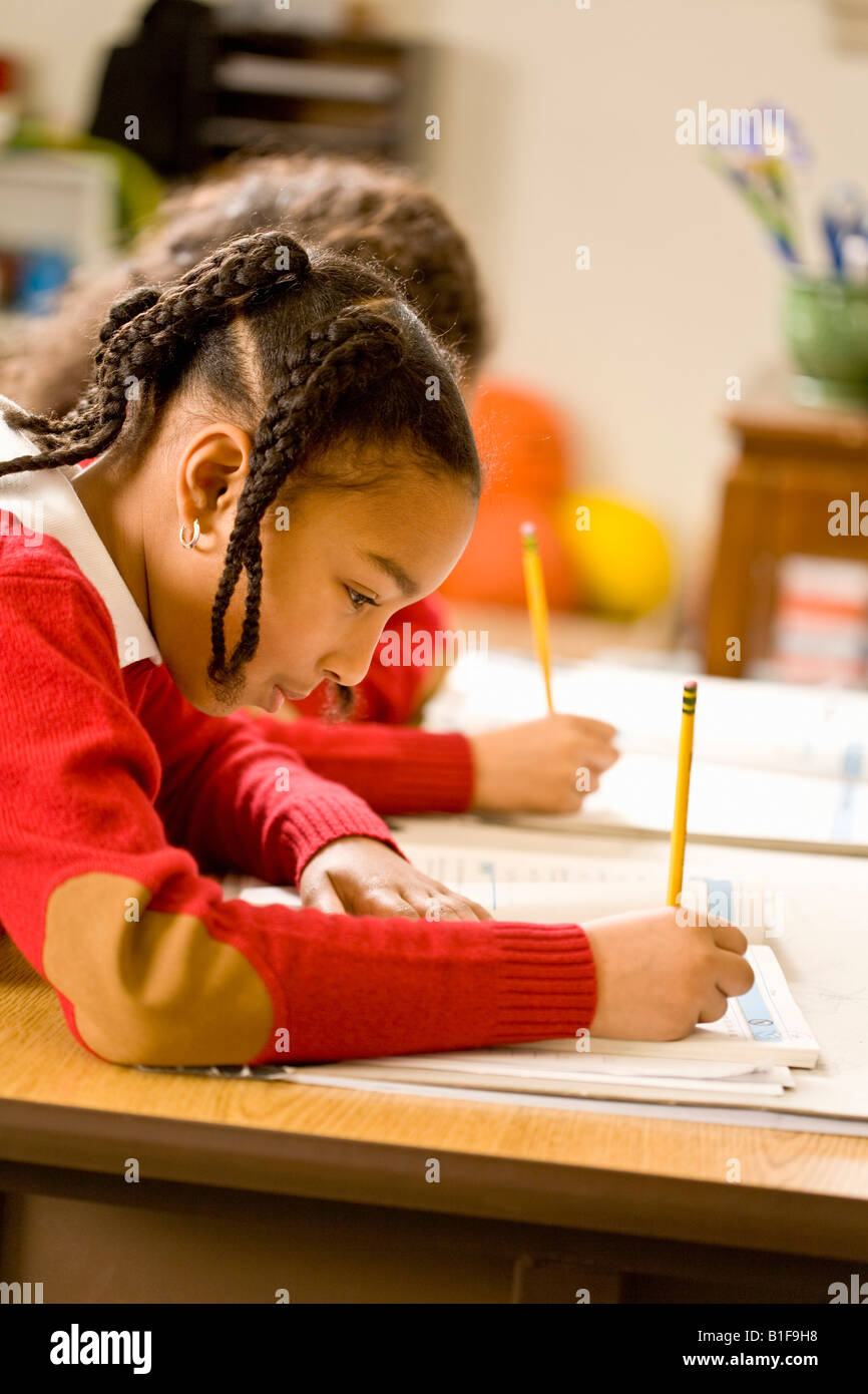 African girl writing at school desk Stock Photo - Alamy