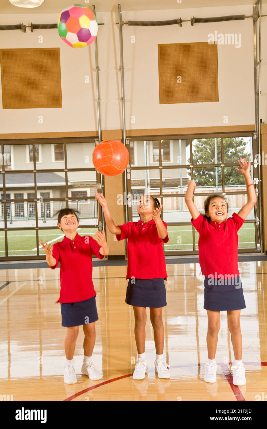 Multi-ethnic girls throwing sports balls Stock Photo - Alamy