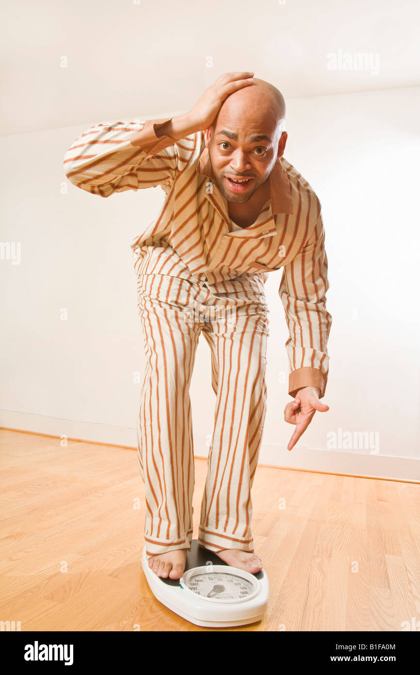 African man standing on scale Stock Photo - Alamy