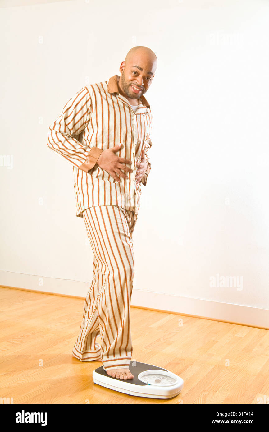 African man stepping onto scale Stock Photo - Alamy