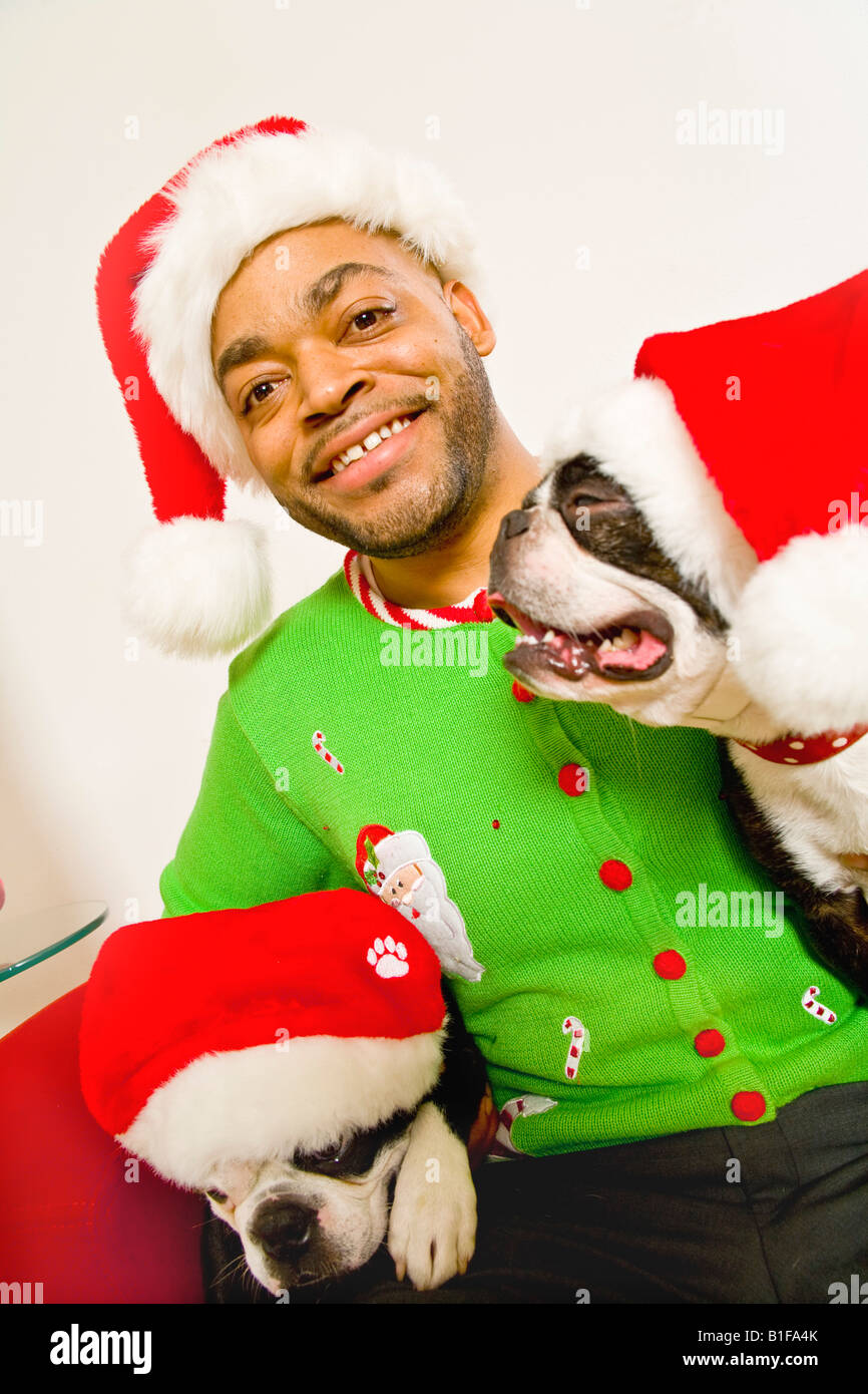 African man and dogs wearing Santa Claus hats Stock Photo - Alamy