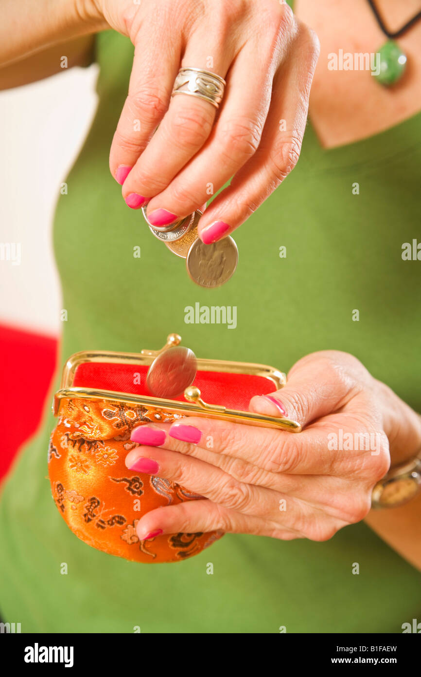 Female hand dropping coin hi-res stock photography and images - Alamy