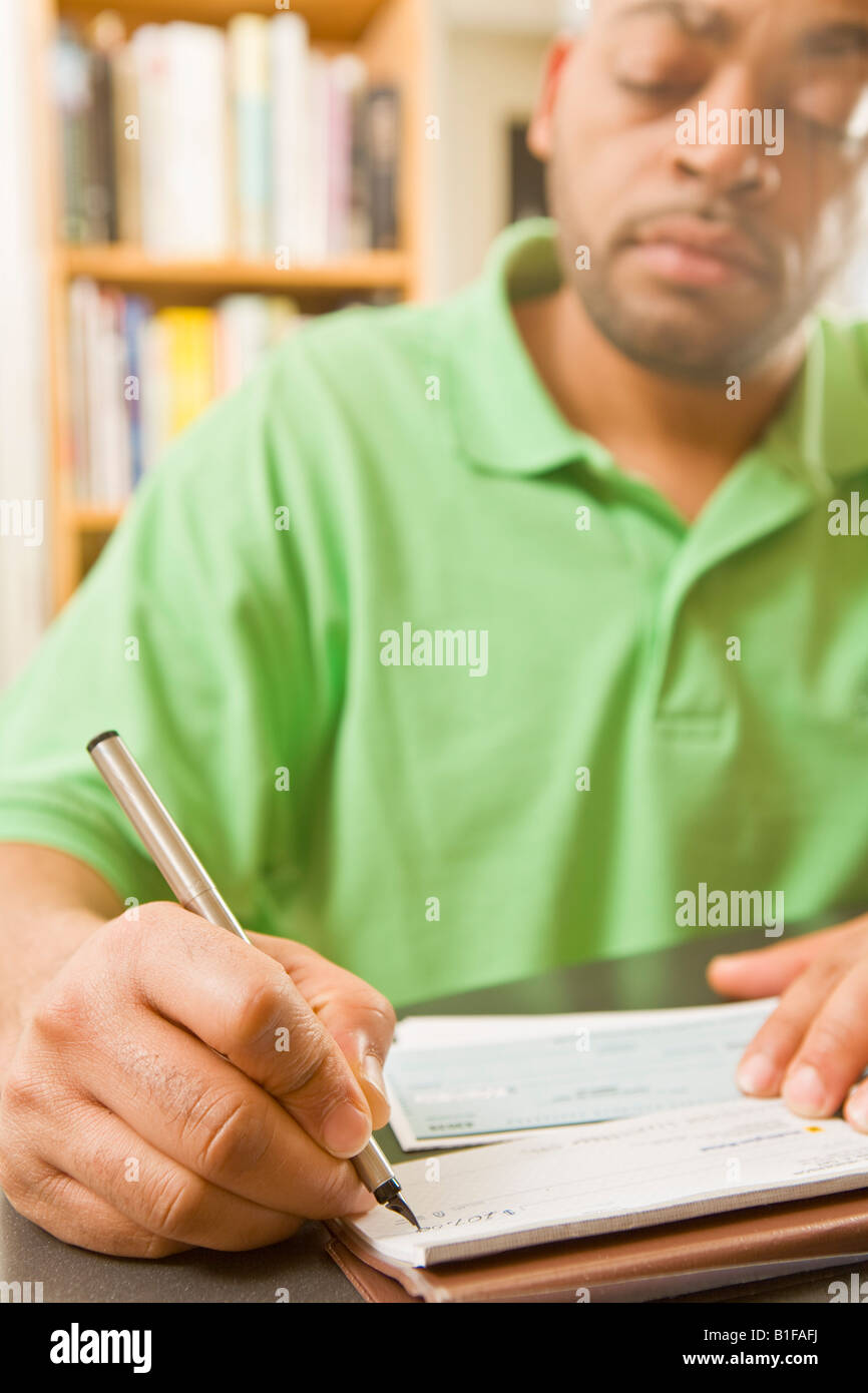 African man writing check Stock Photo - Alamy